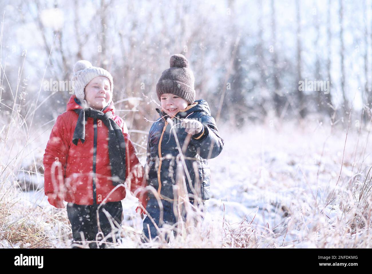 Kids walk in the park with first snow Stock Photo - Alamy