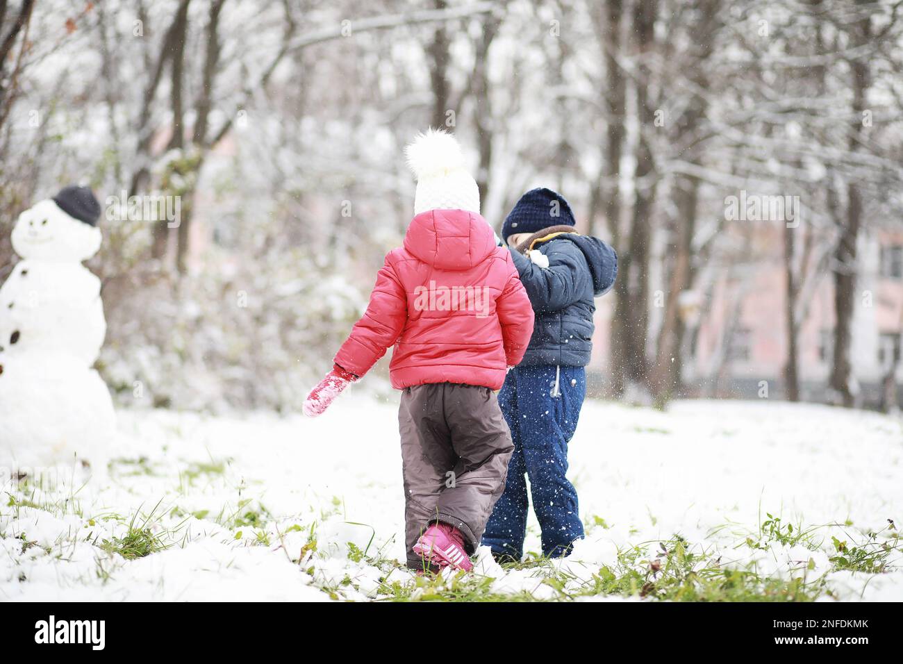 children in winter park play with snow Stock Photo - Alamy