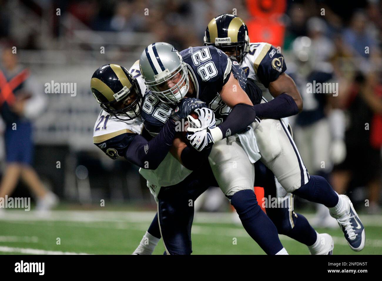 Dallas Cowboys tight end Jason Witten, center, is pulled down by St ...