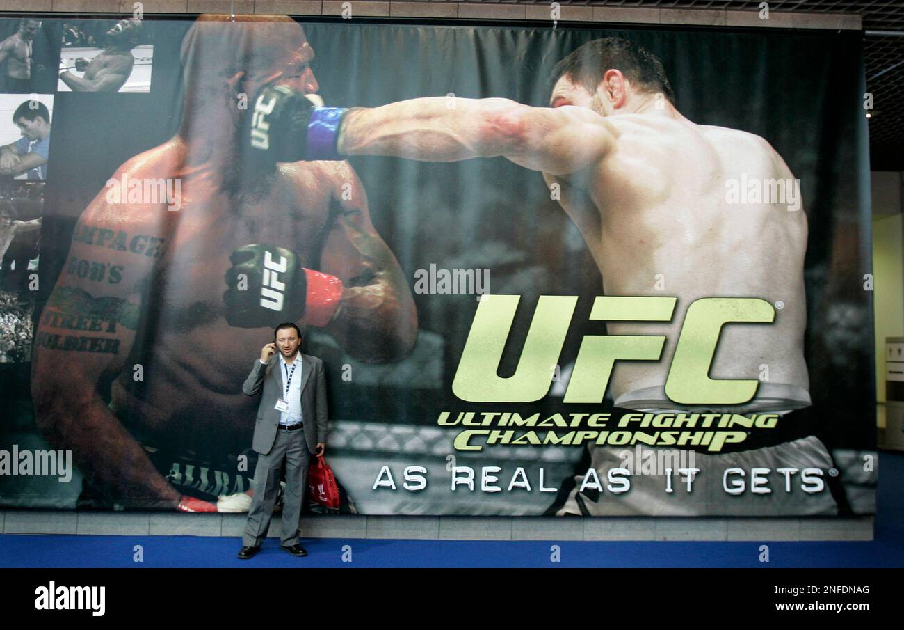 A visitors makes a phone call in front of giant poster at the 19th ...