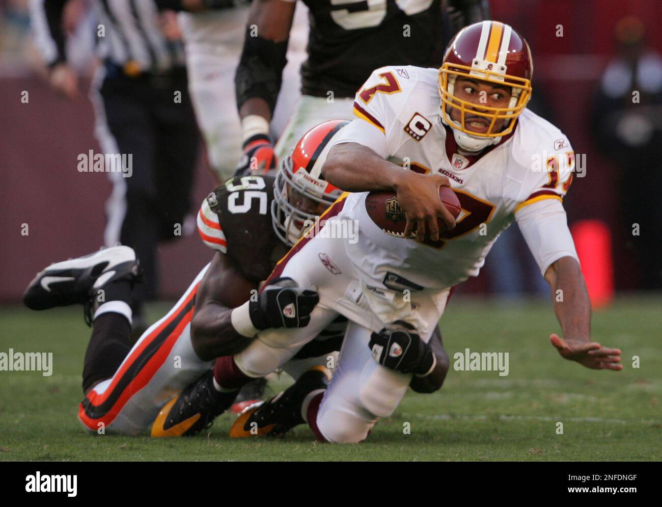 Washington Redskins quarterback Jason Campbell (17) is brought down by ...