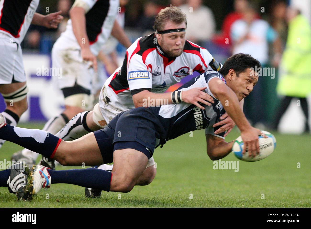 Kevin Senio of Castres, right, is being tackled by Graig Hamilton of ...