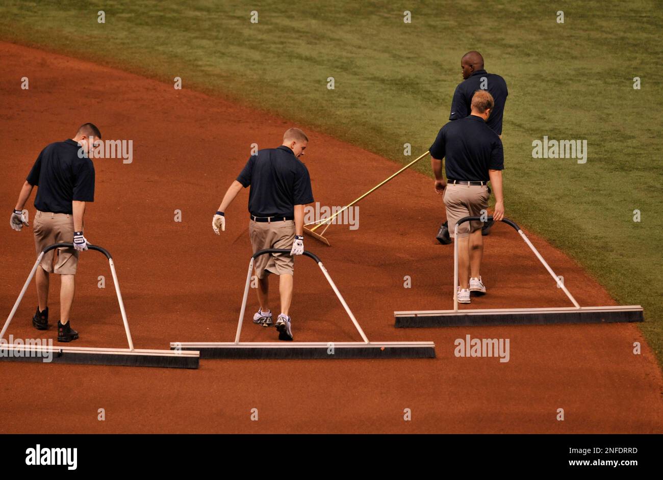 Grounds crew sweep the infield area during the second American League ...