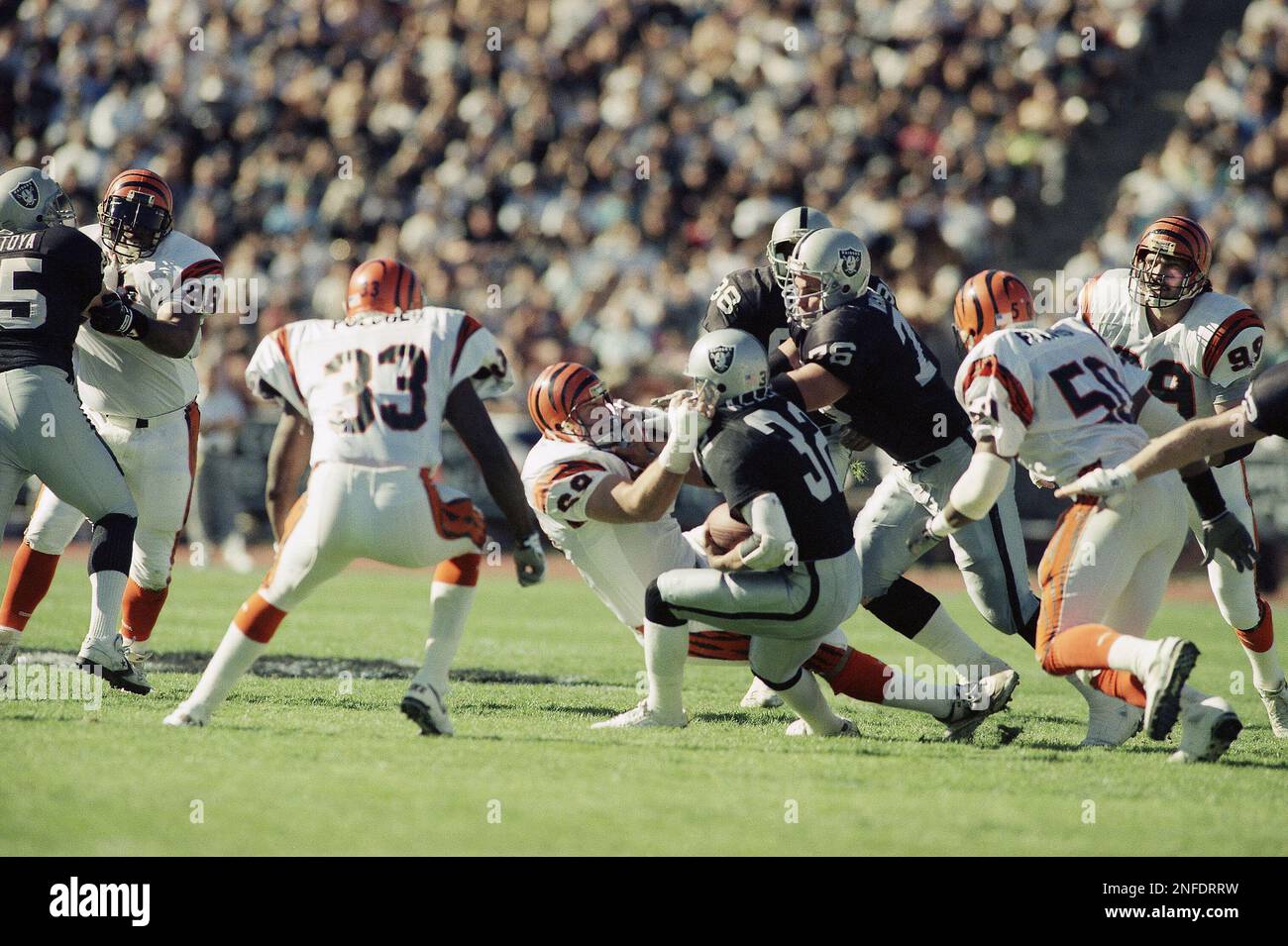 Cincinnati Bengals Tim Krumrie (69) tackles Los Angeles Raiders Marcus ...