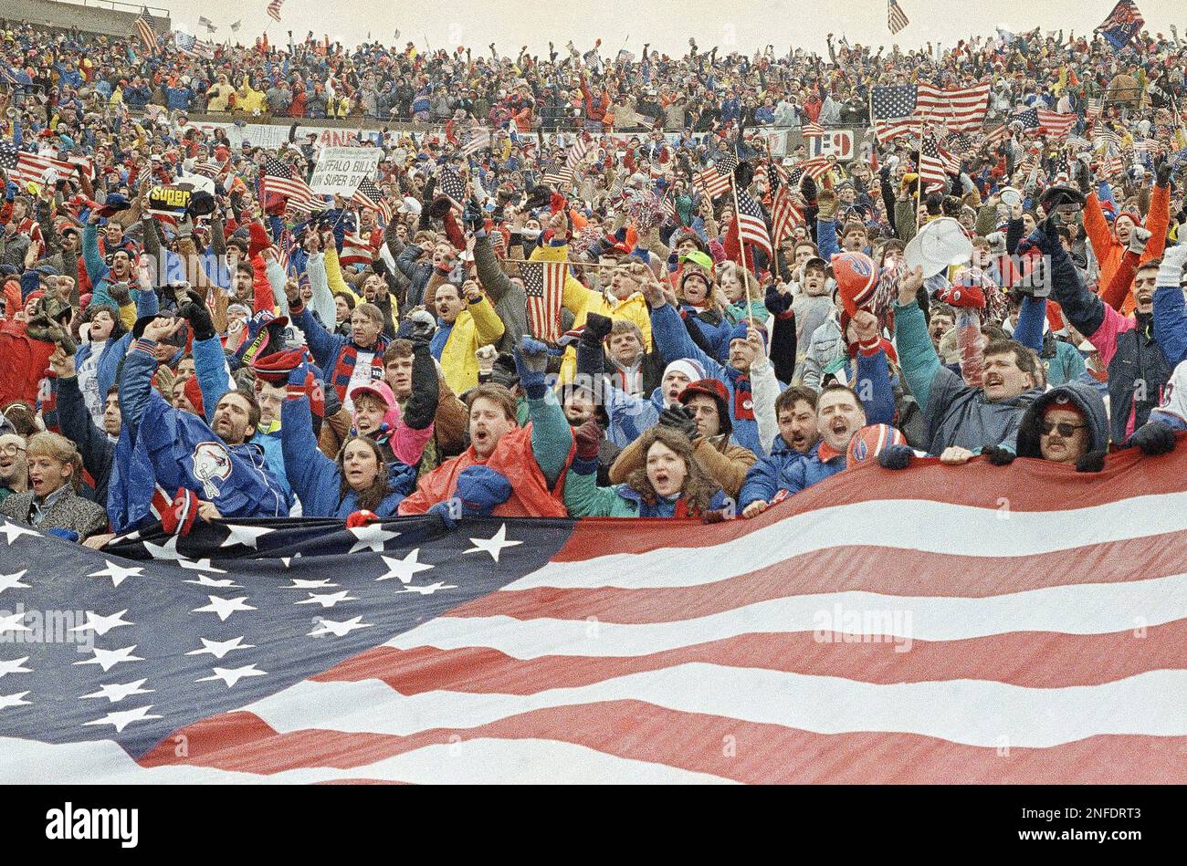 Fans wave American Flags during the National Anthem before the start of ...