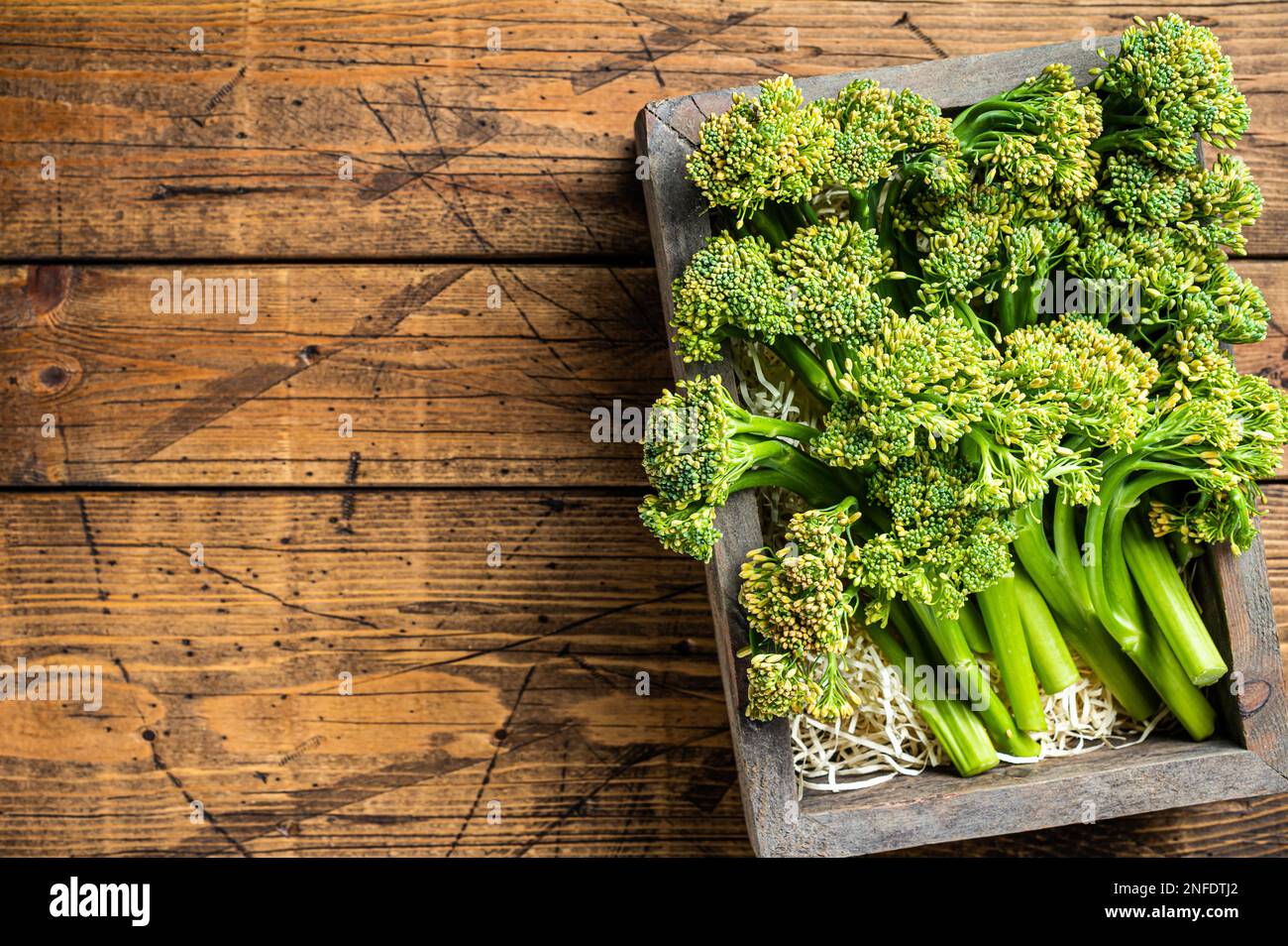 Raw Organic Fresh Broccolini Vegetable in a wooden box. Wooden ...