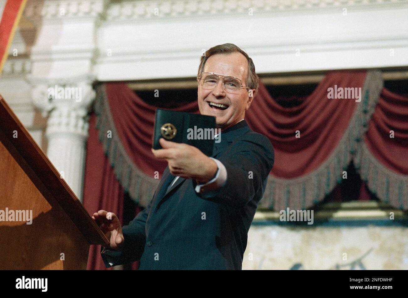 President George Bush shows off the Texas Rangers badge, given to him ...