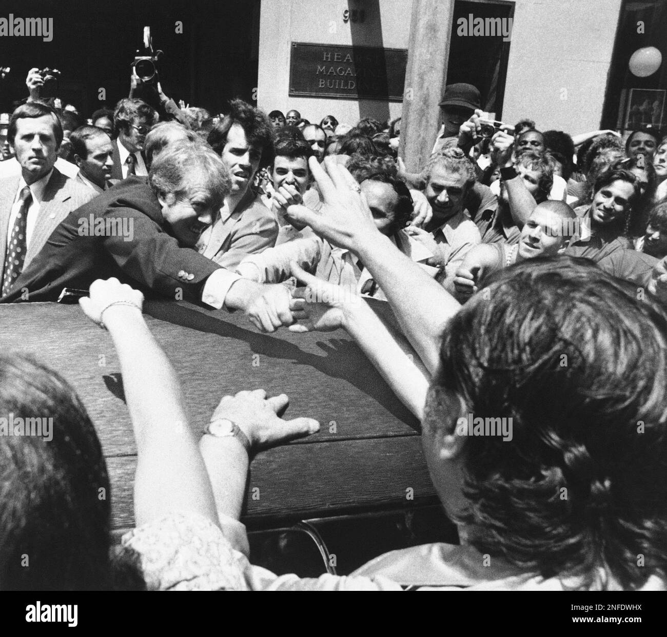 Democratic presidential candidate Jimmy Carter, left, reaches across ...