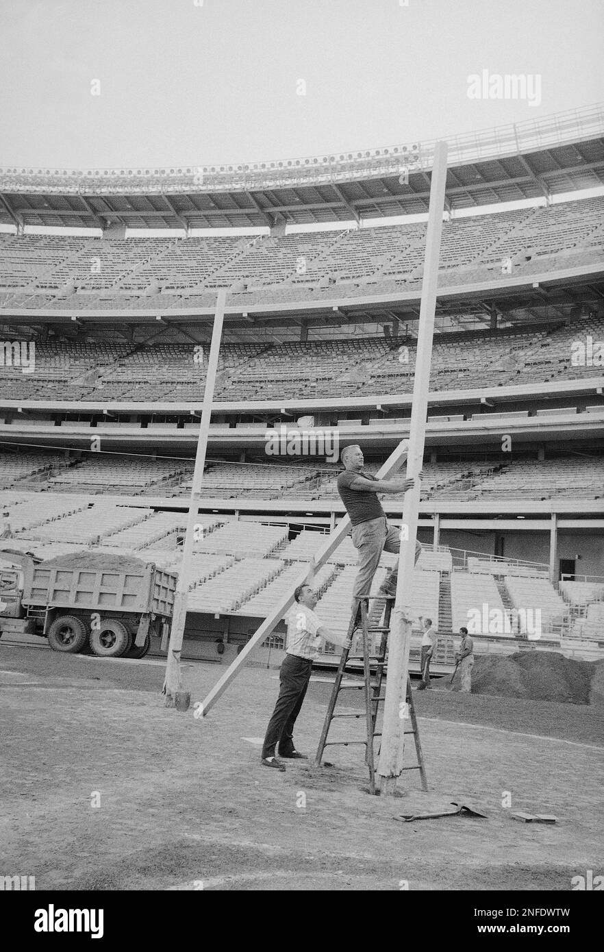Workers put up goal posts near homeplate, Sept. 10, 1964, at New York's ...
