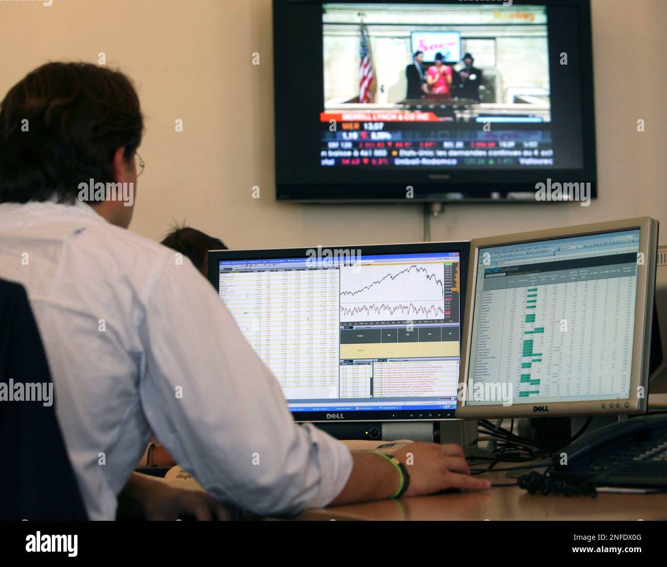 A trader works at his office in Paris Thursday Oct.16, 2008. European ...