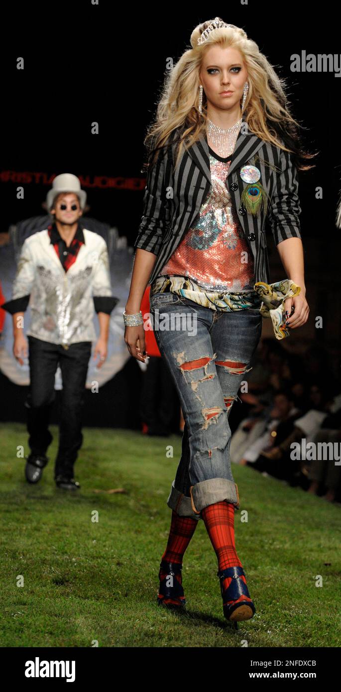 A model walks the runway at the Christian Audigier Presents American ...