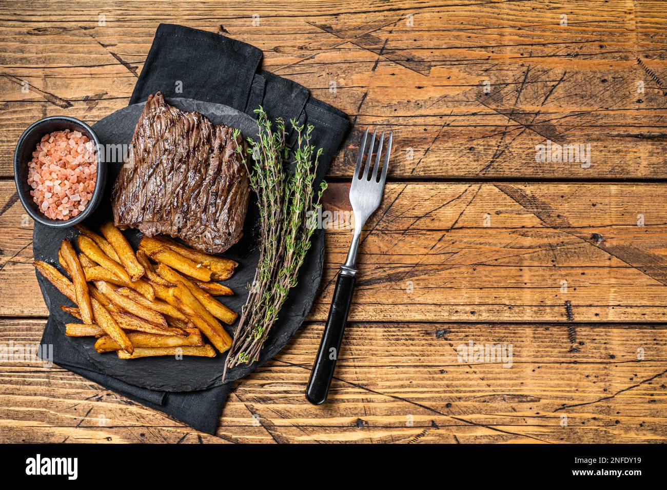 Venison dear steak with sea salt and french fry, game meat. Wooden ...