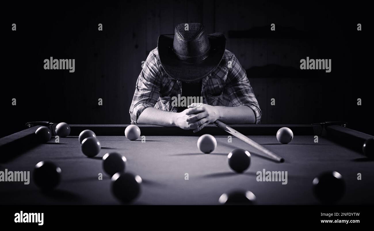 A man with a beard plays a big billiard. Party in 12-foot pool ...