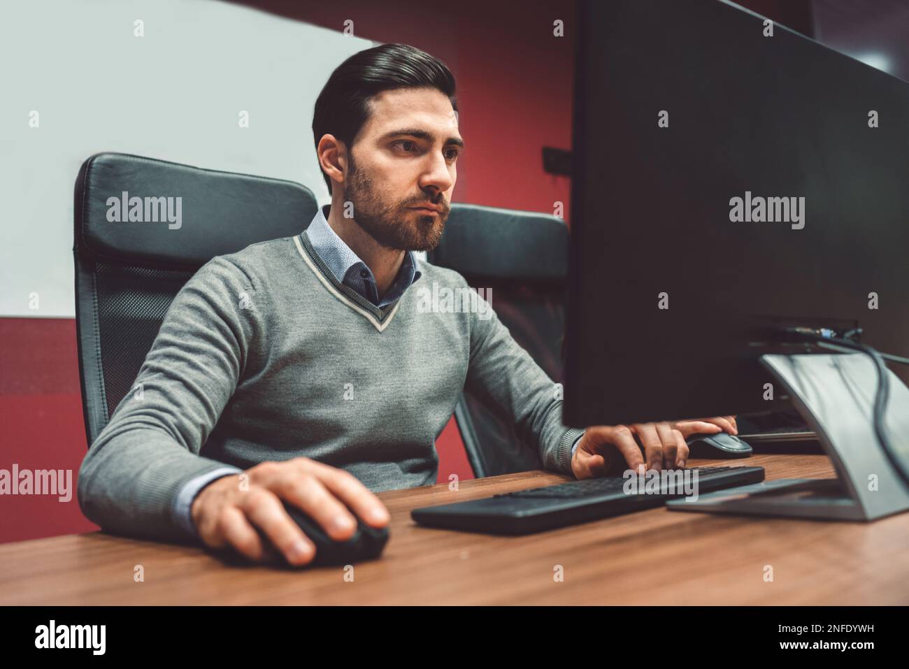 Serious look on businessman's face while he works on computer in the ...