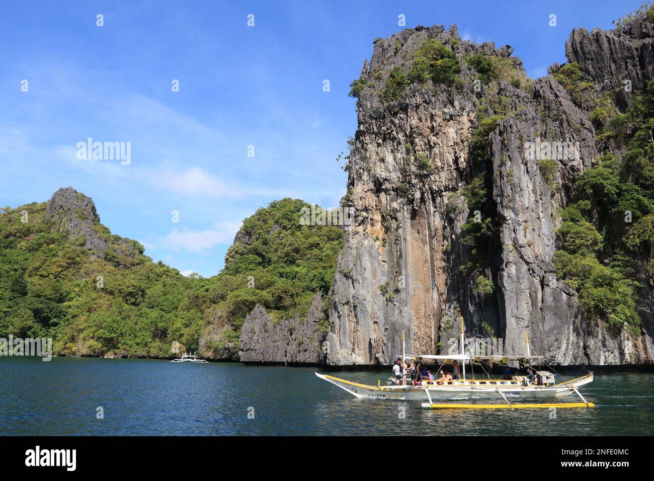 PALAWAN, PHILIPPINES - DECEMBER 1, 2017: People ride outrigger bangka ...