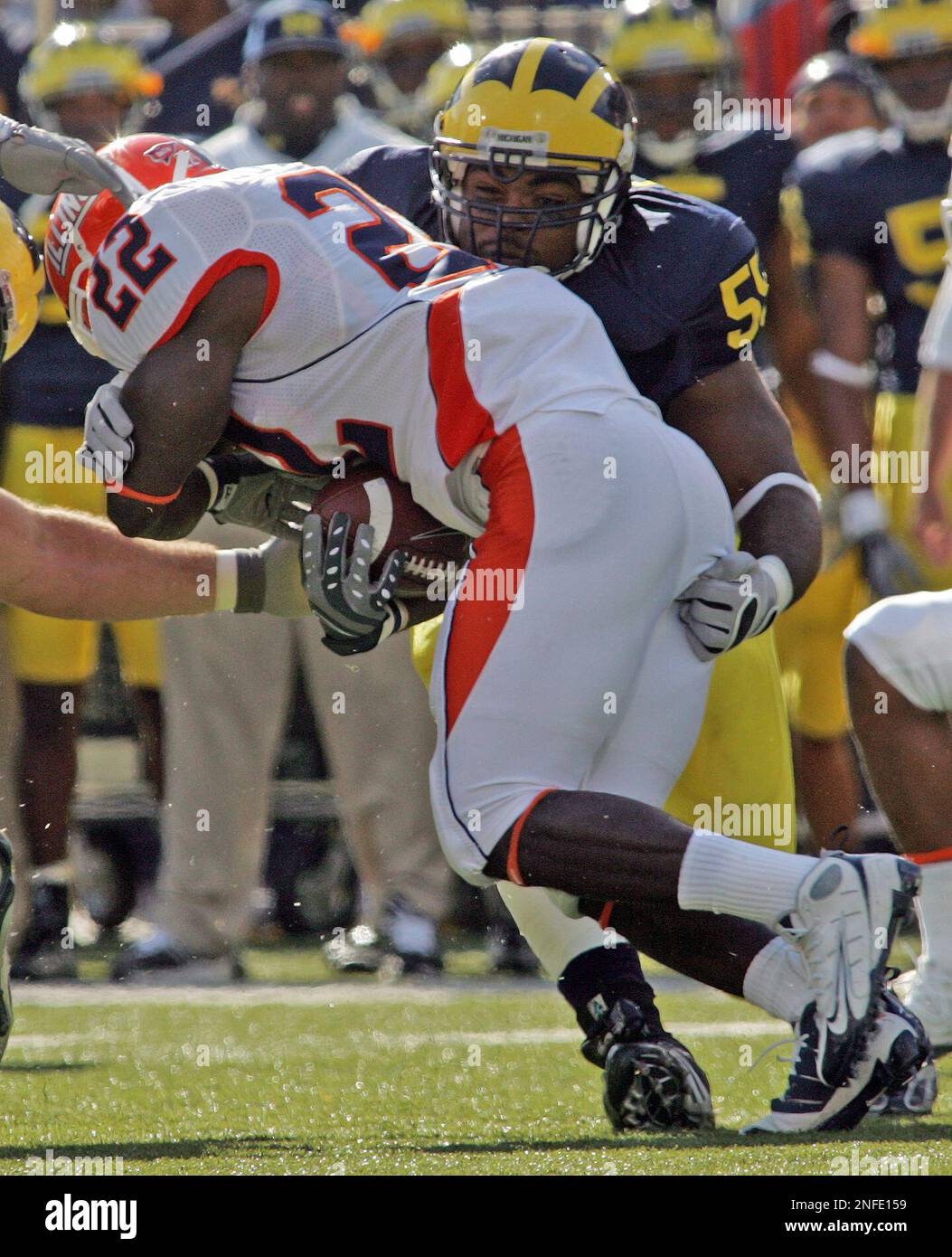Michigan defensive end Brandon Graham, back center, tackles Illinois ...