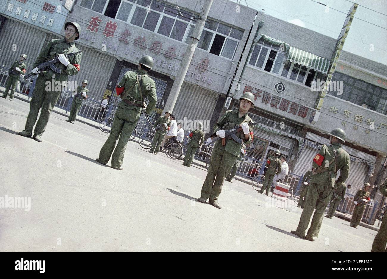 People's Liberation Army troops guard an intersection in central ...