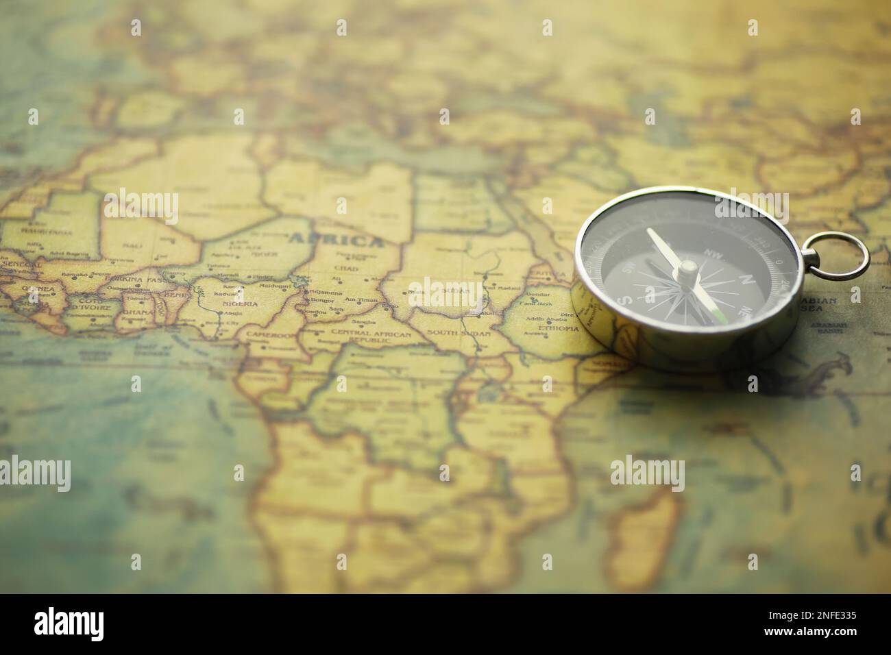 Travel and adventure search concept. Vintage aged map with shabby book ...