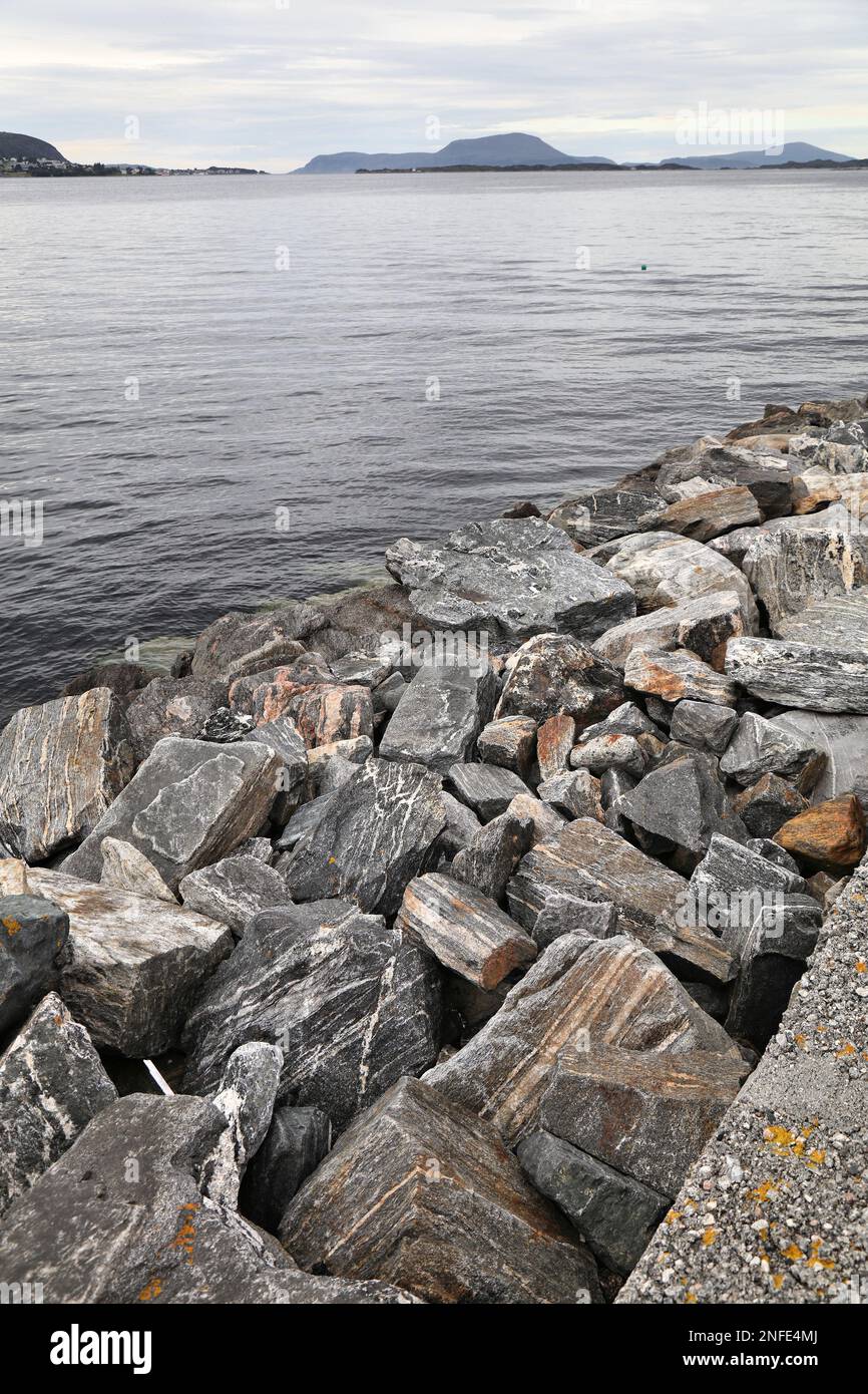 Banded gneiss stone boulders used in rubble mound breakwater in Norway ...