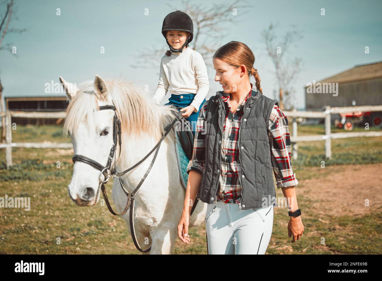 .Woman, child on horse and happy ranch lifestyle and animal walking on field with girl, mother ...