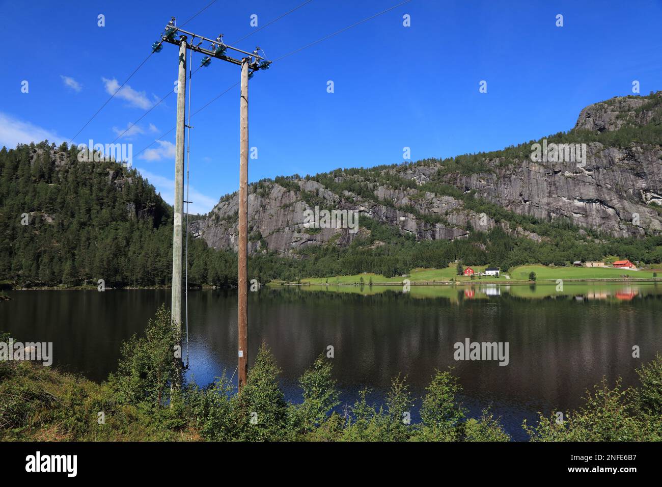 Lake side village in Setesdal, Norway. Wooden electric pole in Agder ...