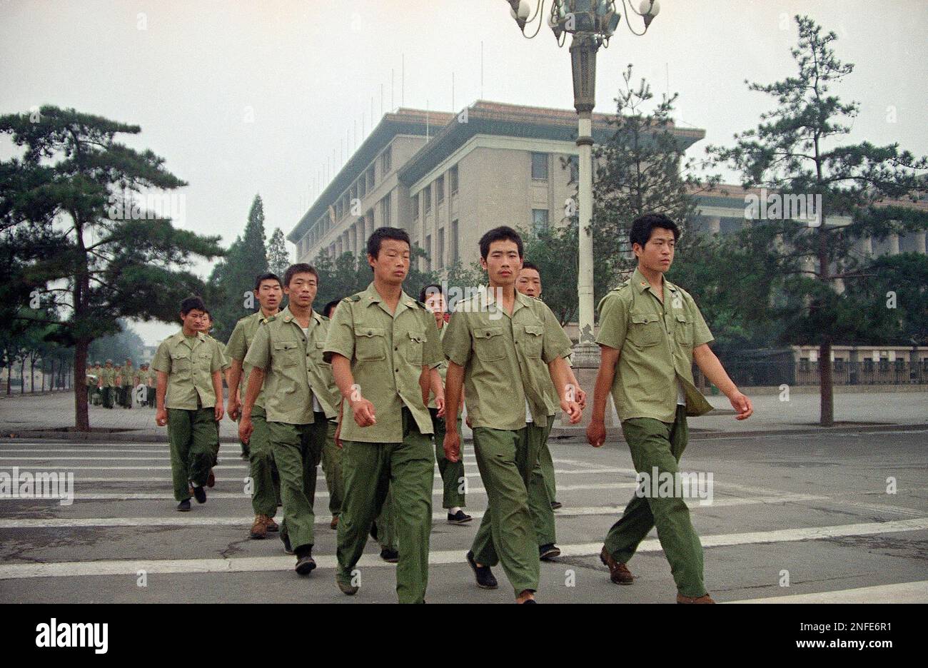 A squad of Peoples Liberation Army soldiers march across Tiananmen ...