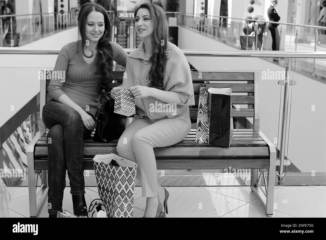 Two cute girls go shopping in the mall Stock Photo - Alamy