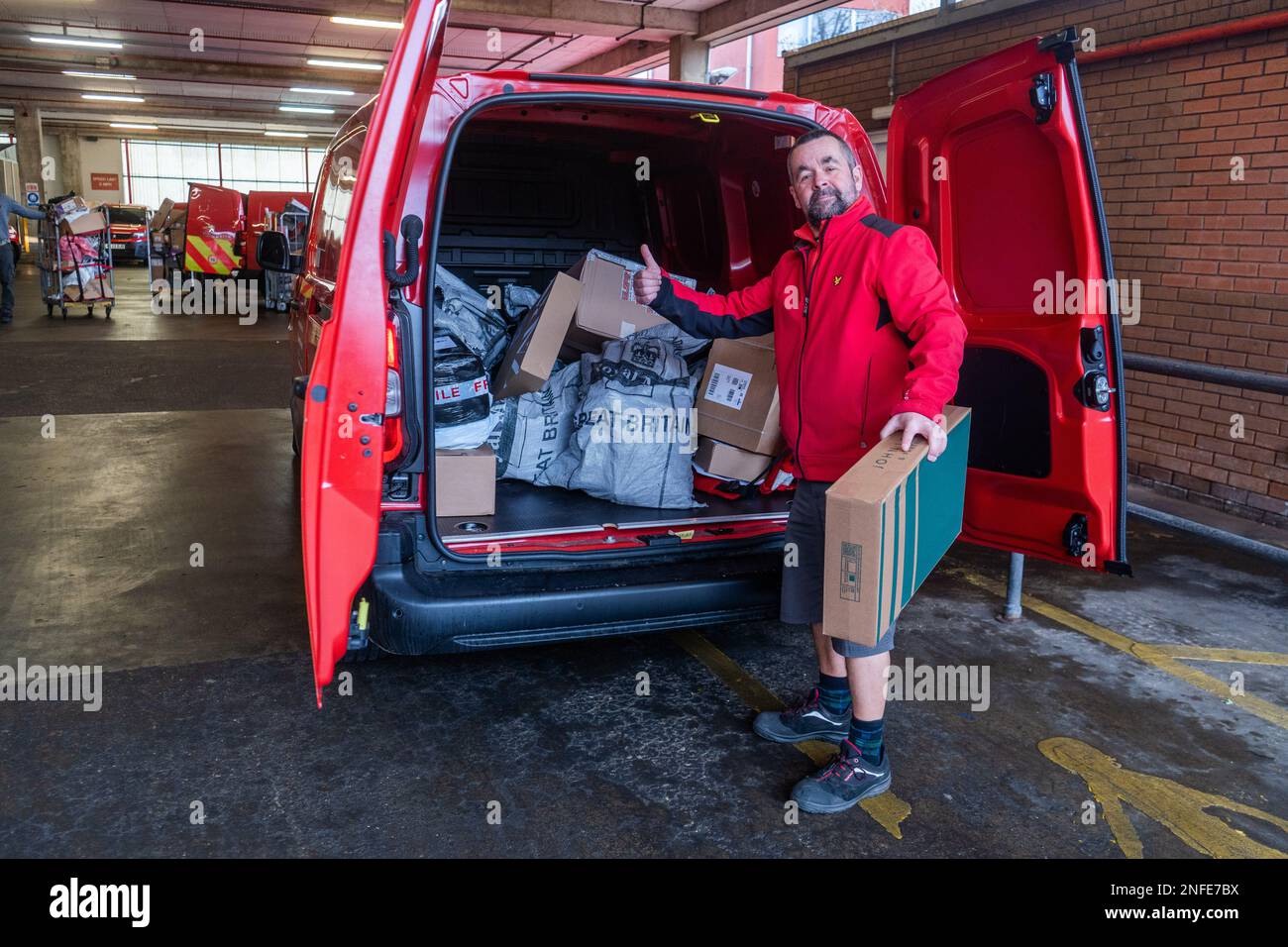London, UK. 17 February 2023. A postal worker gives the thumbs up as he ...