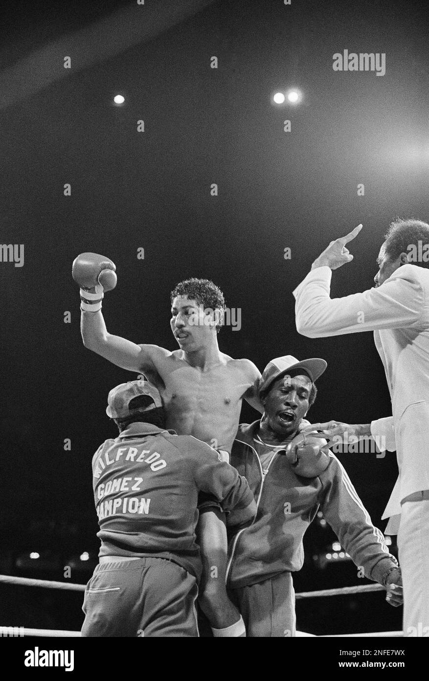 Wilfredo Gomez of Puerto Rico is lifted by members of his training team ...