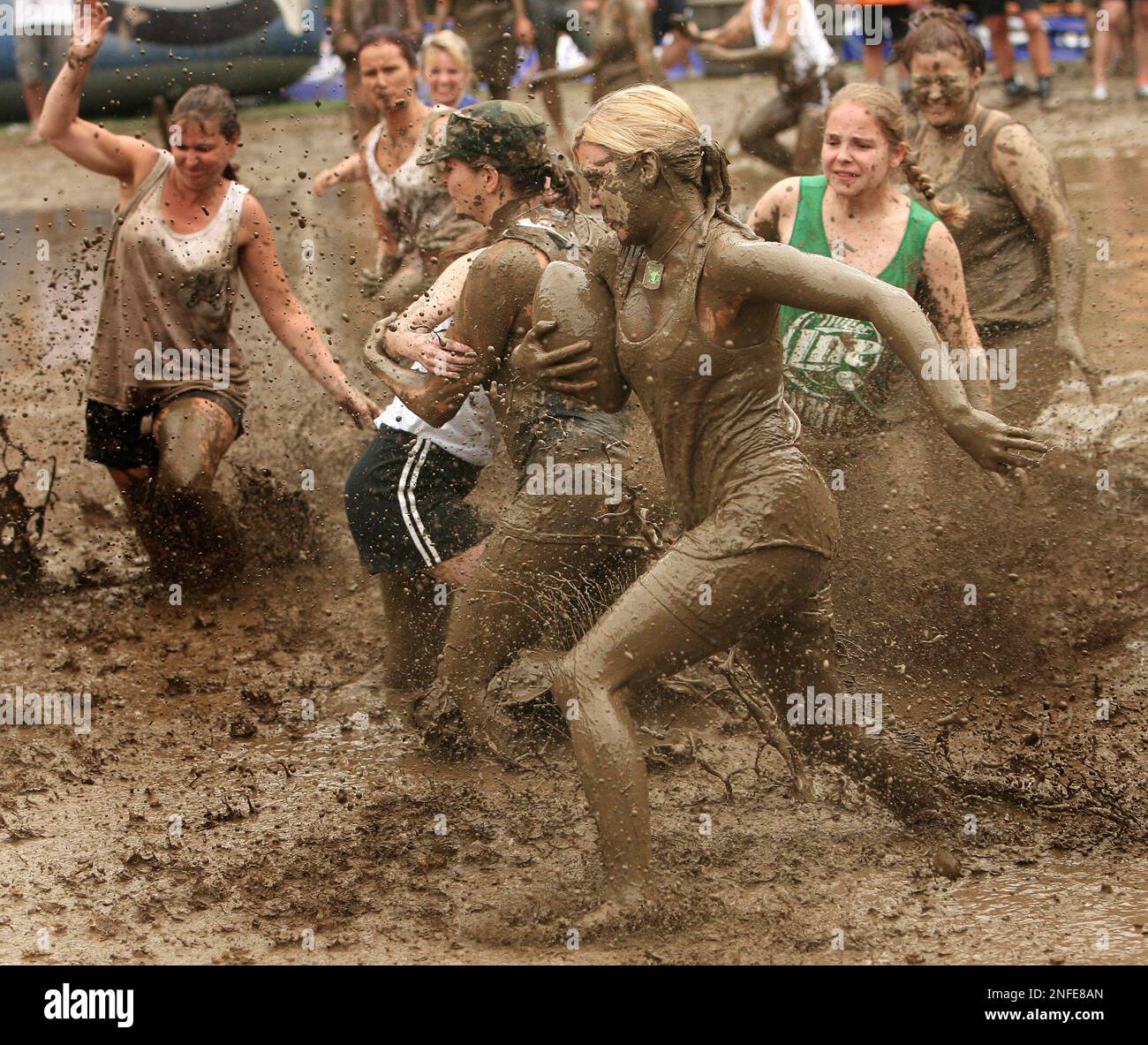 Cheerleaders play a half time game during the World Mud Bowl ...