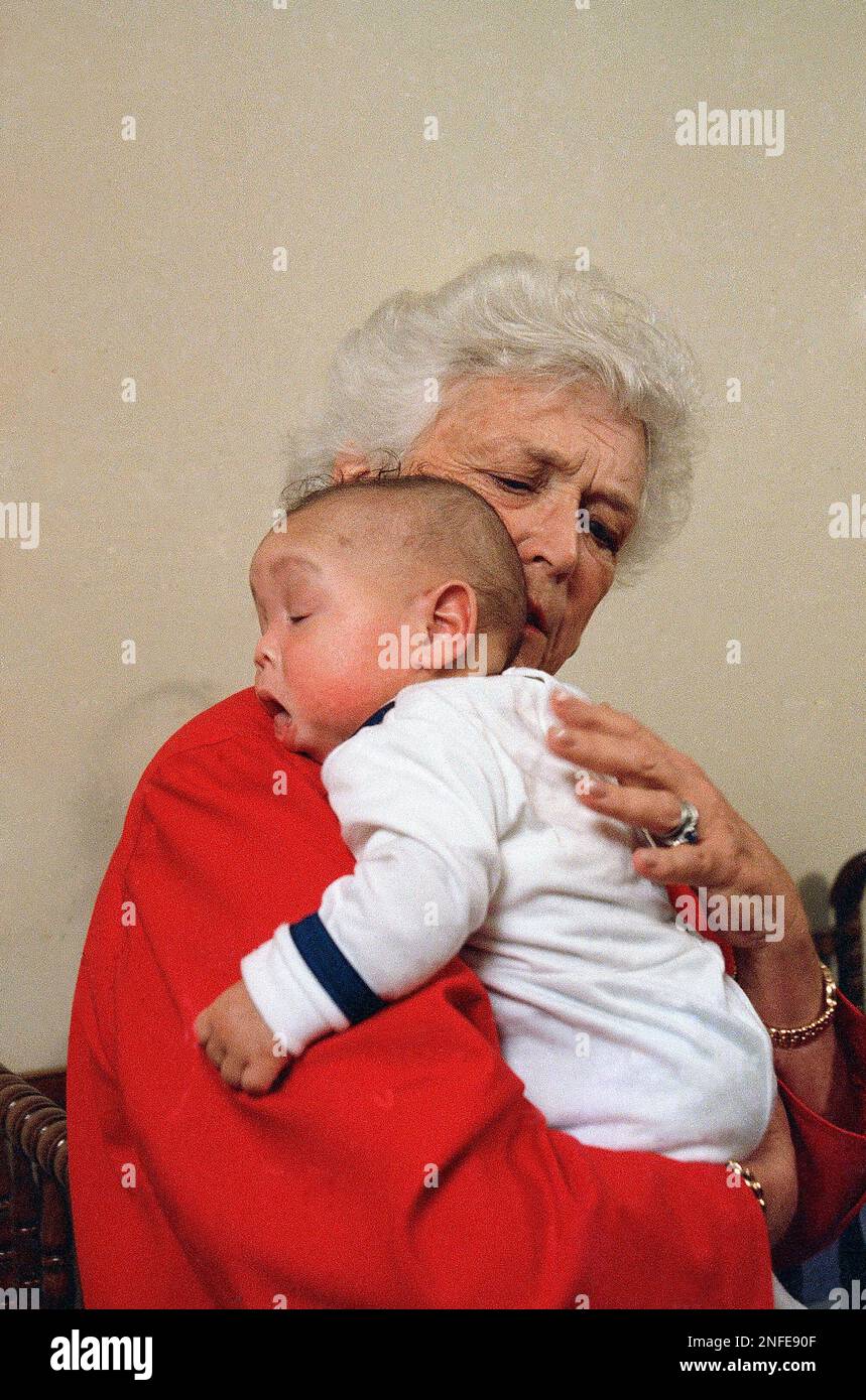 First lady Barbara Bush holds an infant identified as Donavan during a ...
