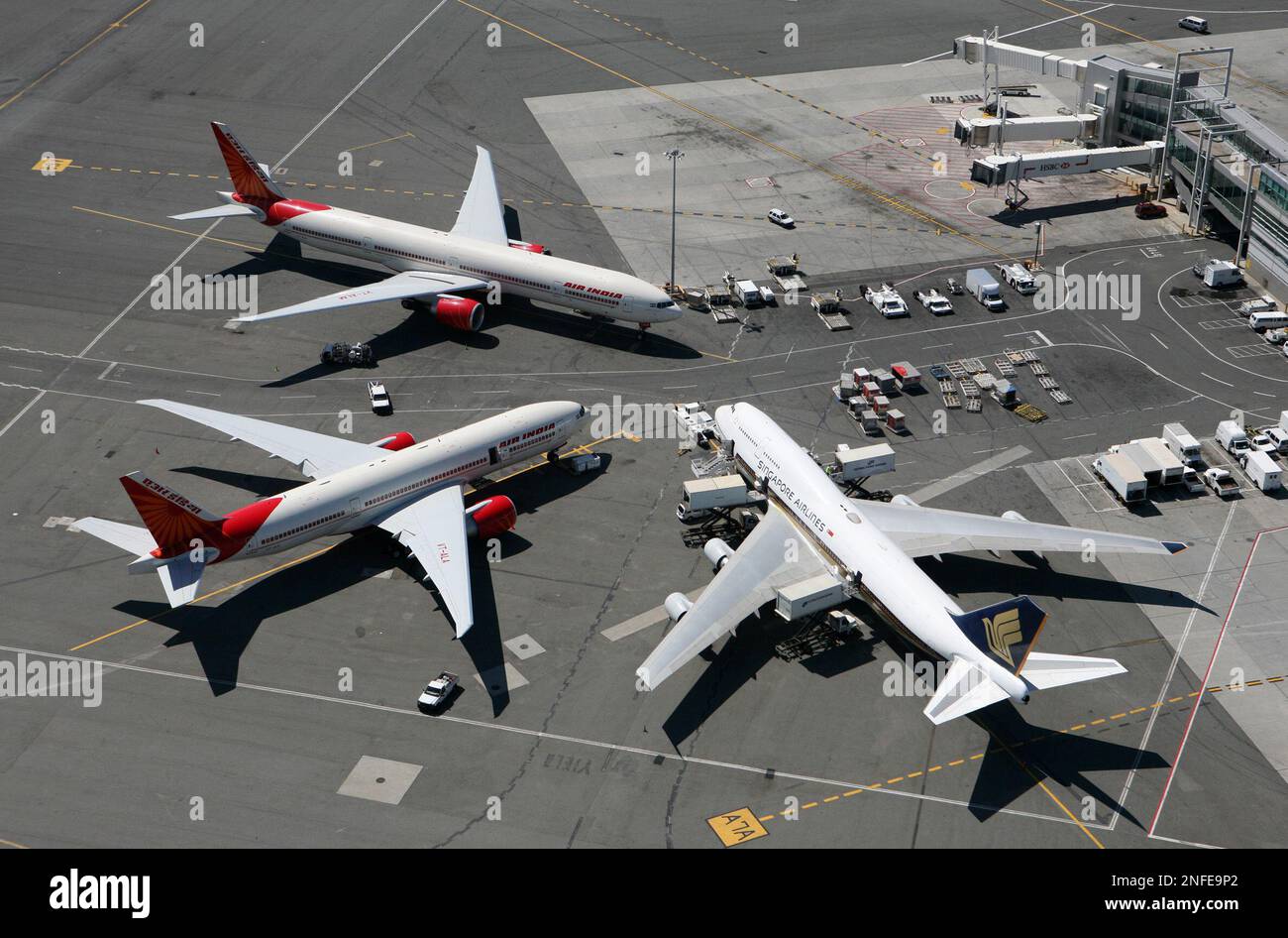 Jet aircraft with Air India and Singapore Airlines are parked at a John ...