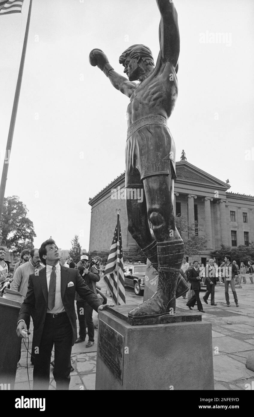 Actor Sylvester Stallone, left, touches a statue of himself that will ...