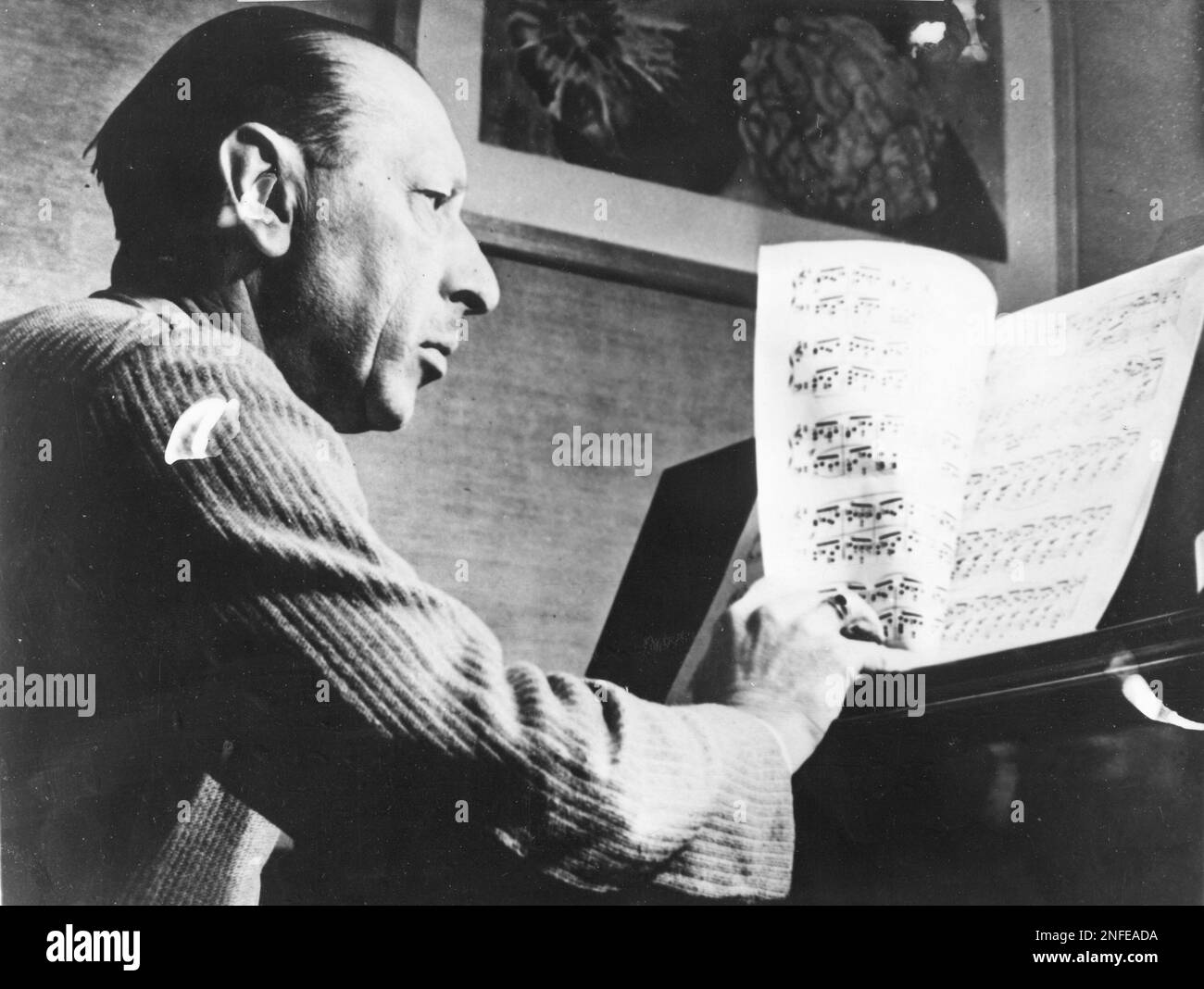 Russian composer Igor Stravinsky is seen sitting at a grand piano ...