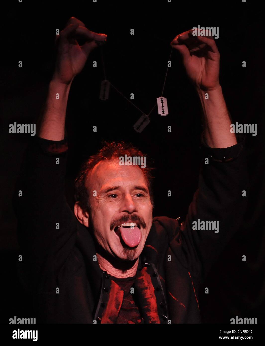 Sideshow MC Jim Rose performs his razor blade swallowing trick during ...