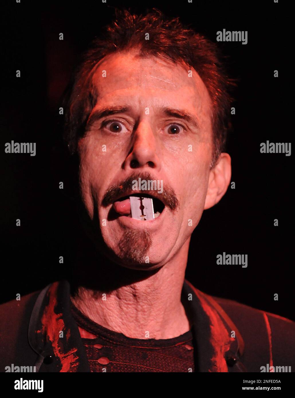 Sideshow MC Jim Rose performs his razor blade swallowing trick during ...