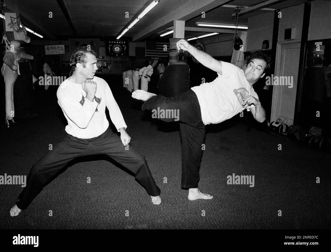 Actor-comedian John Belushi works out with his karate instructor Bill Wallace, left, in 1981 ...