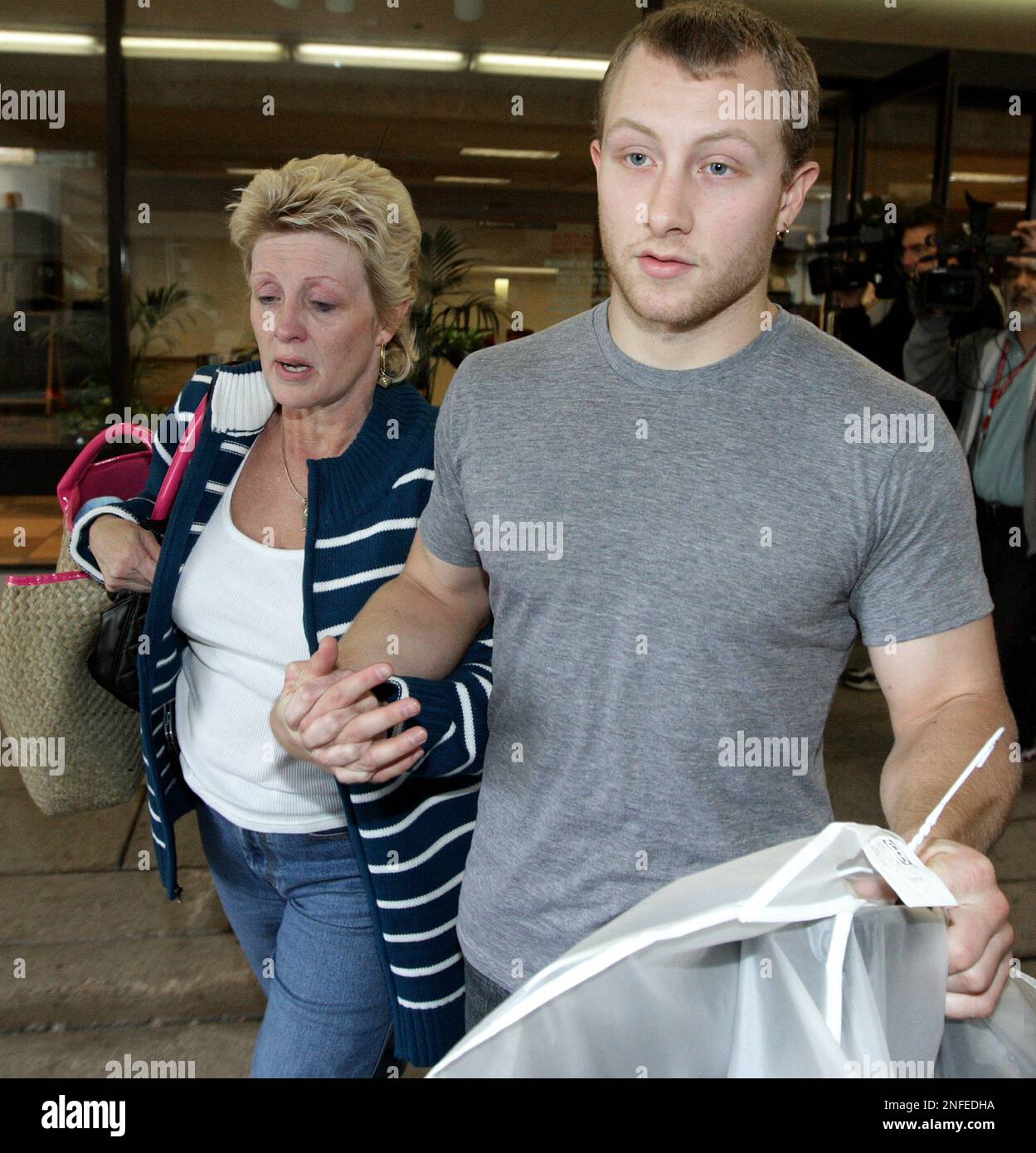 Nathan Fry's mother, Joanne, left, and his brother, Brandon, hold hands ...