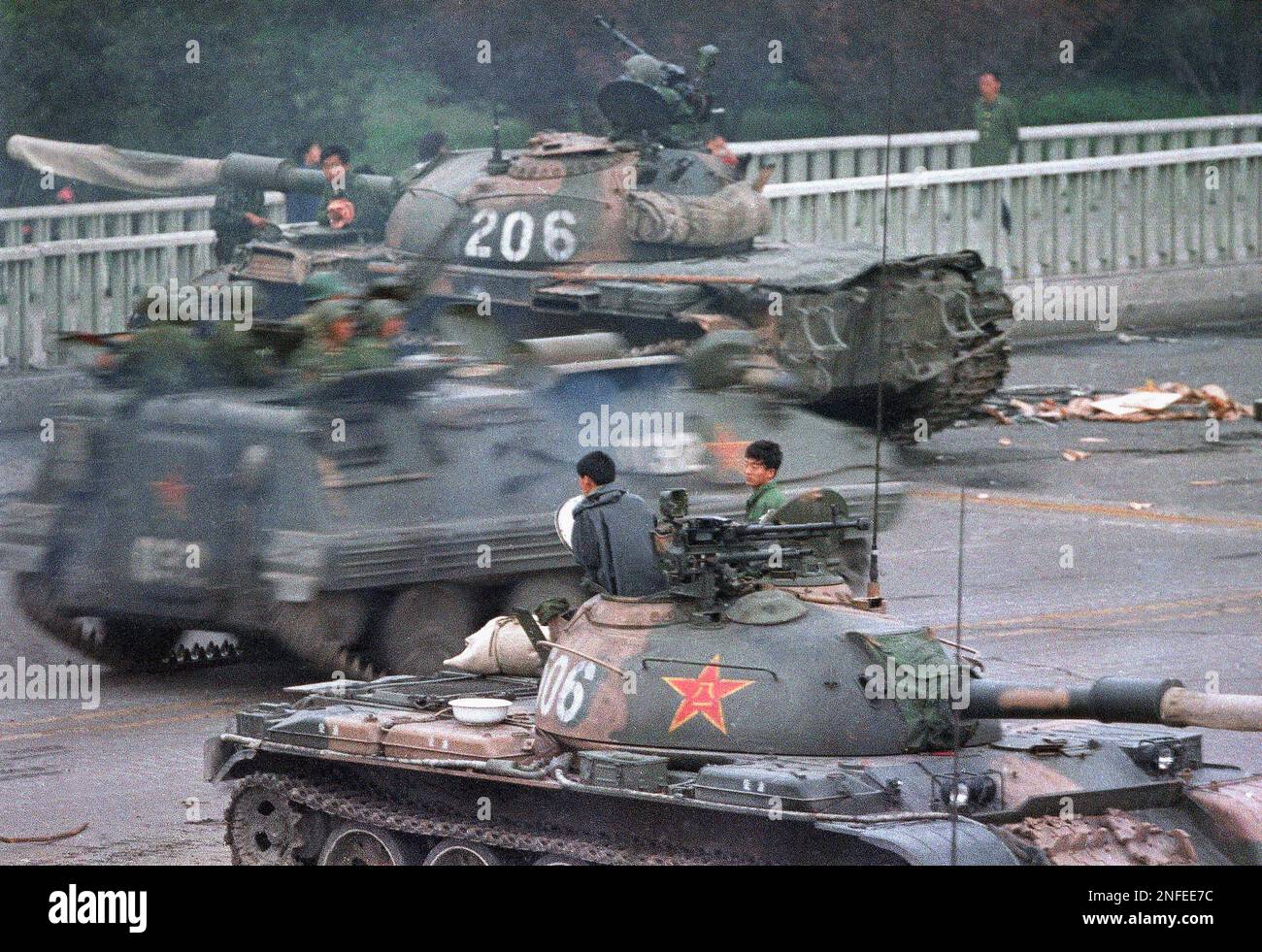An armored personnel carrier races west past tanks strategically ...