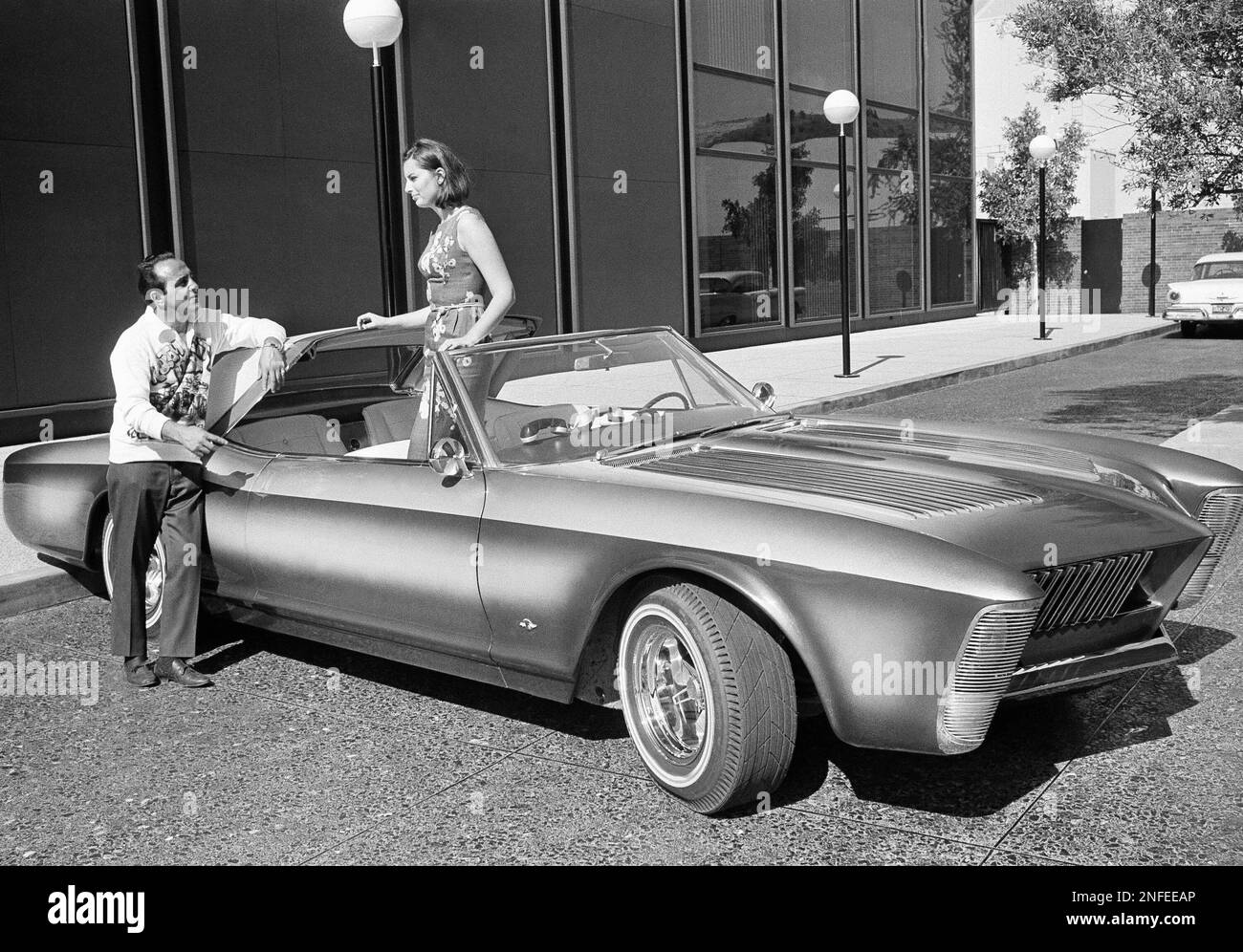 George Baris, left, and model Sandy Braddock, pose beside a Buick ...