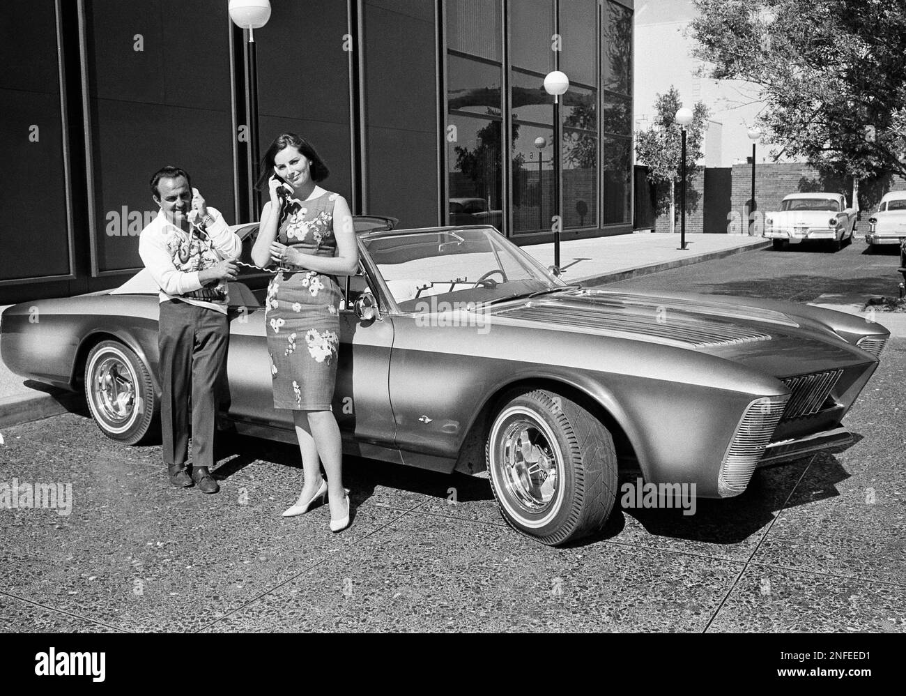 George Baris, left, and model Sandy Braddock, pose beside a Buick ...