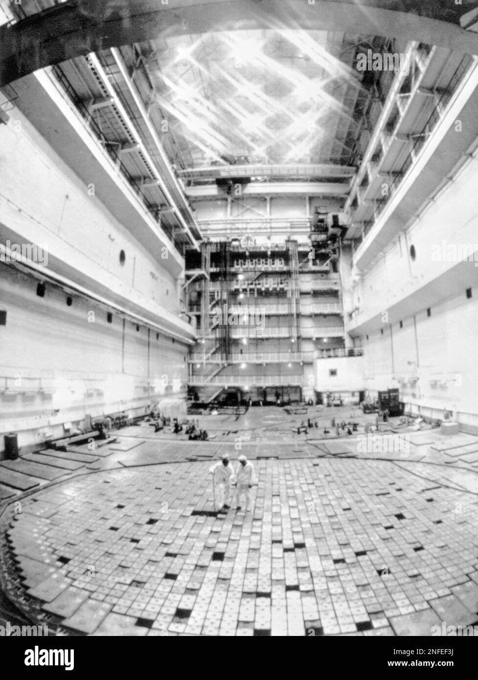 Workers in a reactor room of the Chernobyl nuclear power plant go about ...