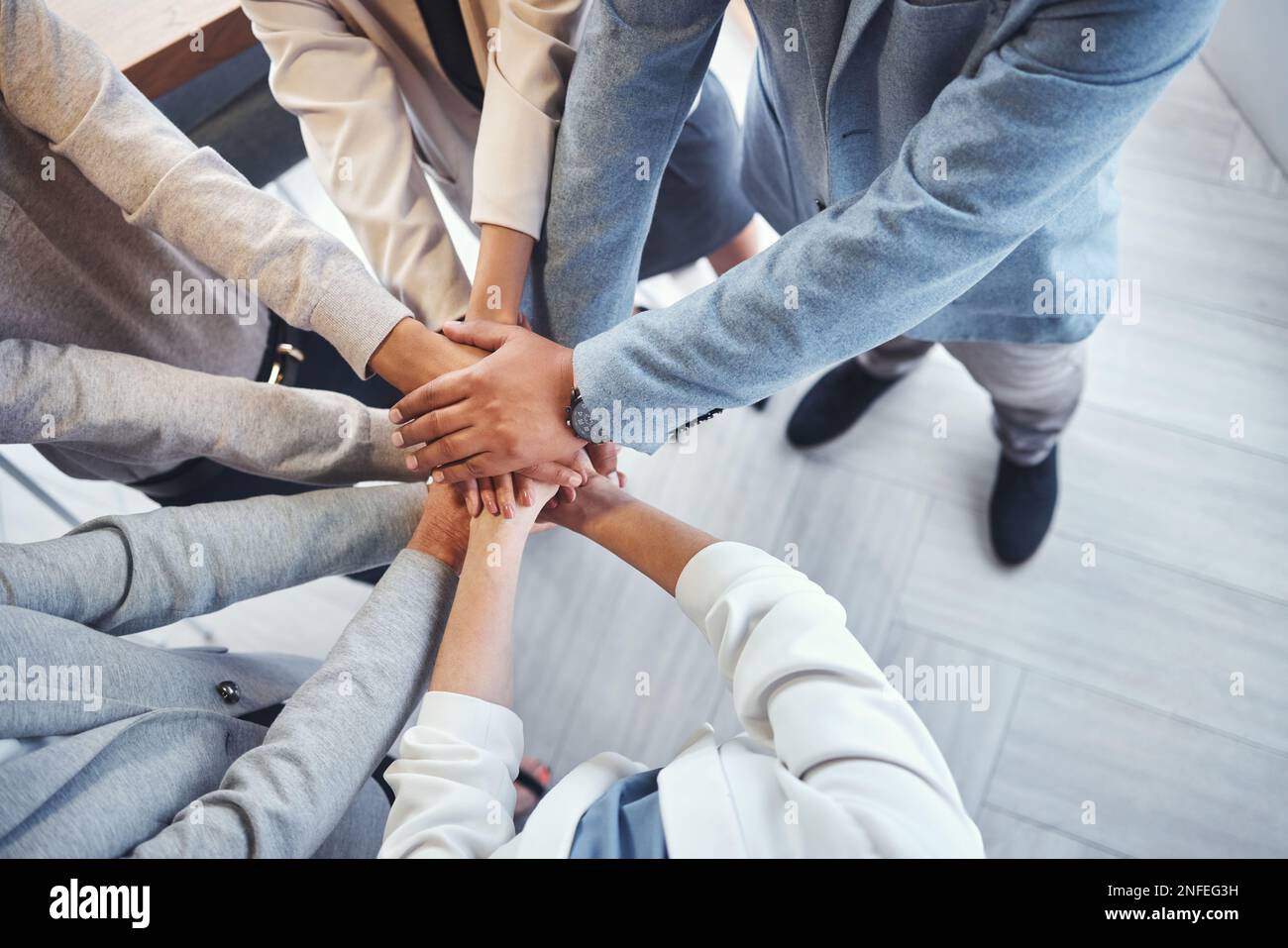 Diversity, stack of hands and business people in the office in unity ...