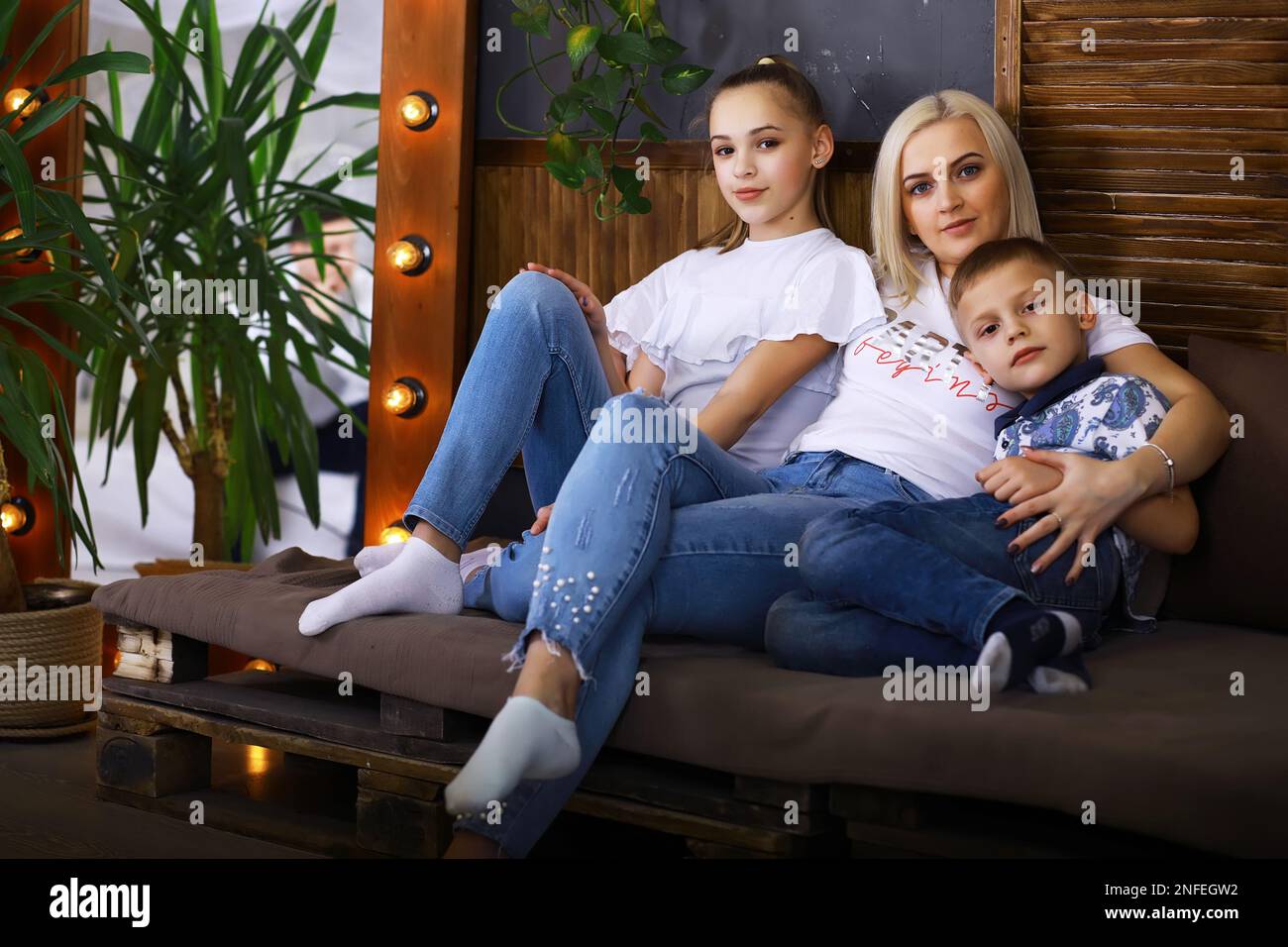 Funny active family of young adult parents and cute small children ...