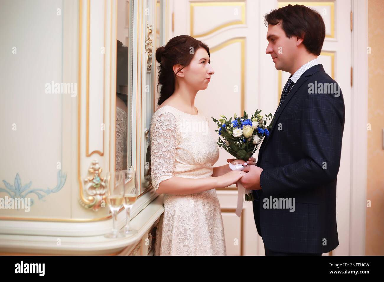 Portrait of emotional lovers of brides indoor.Bride and groom kisses ...