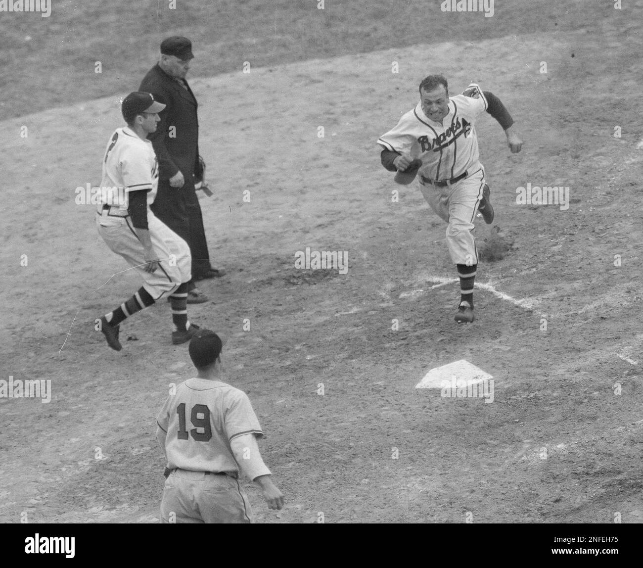 Relief pitcher Gene Bearden is half-carried and half dragged off the ...