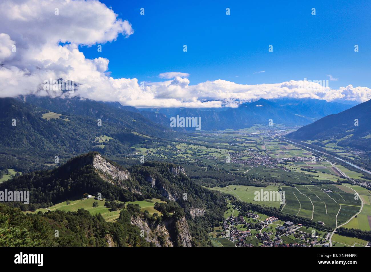 A scenic aerial view of a town surrounded by agricultural fields and ...