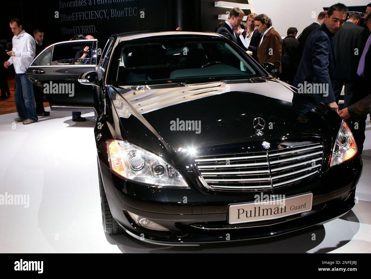 Visitors take a look at the armored Mercedes Pullman Guard at the first ...