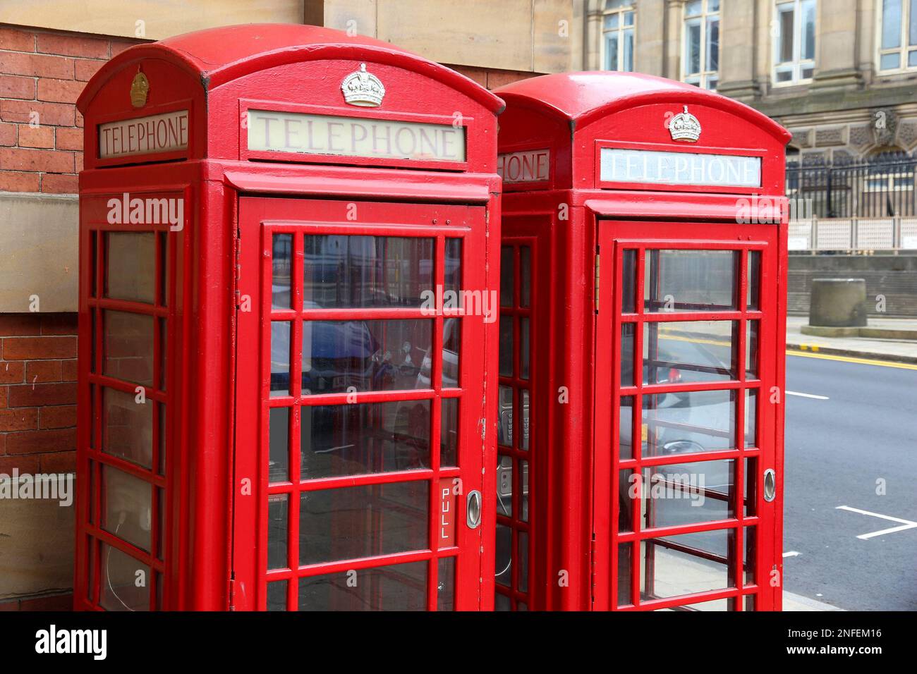 Leeds city in the UK. Red telephone booths Stock Photo - Alamy