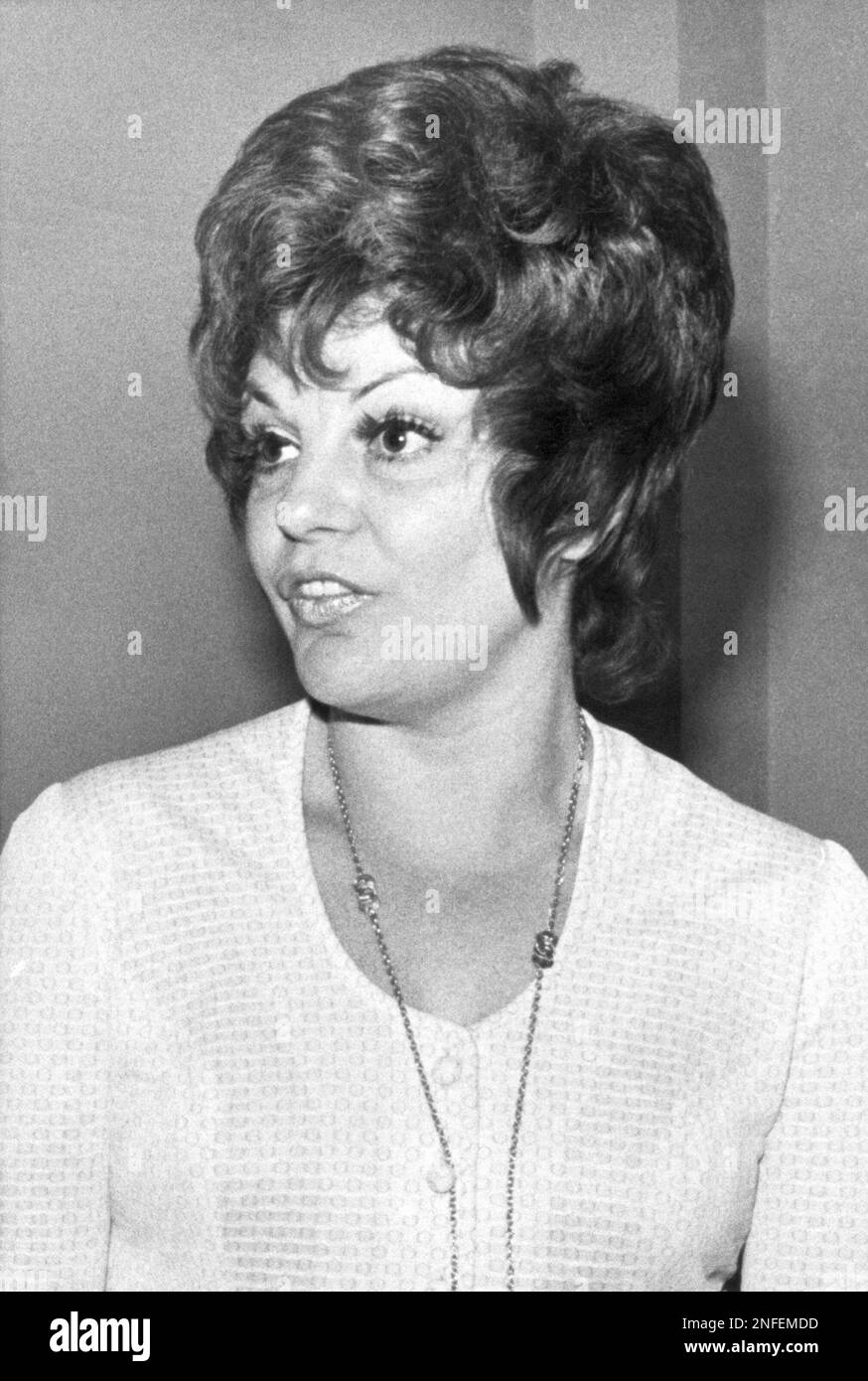 Mrs. Virginia Castro, 37, talks to photographers as she waits to ...